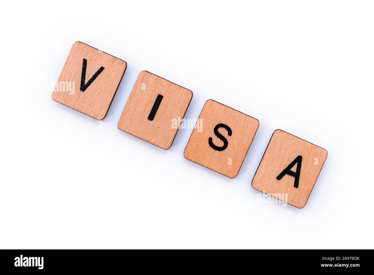 The word VISA, spelt with wooden letter tiles over a white background ...
