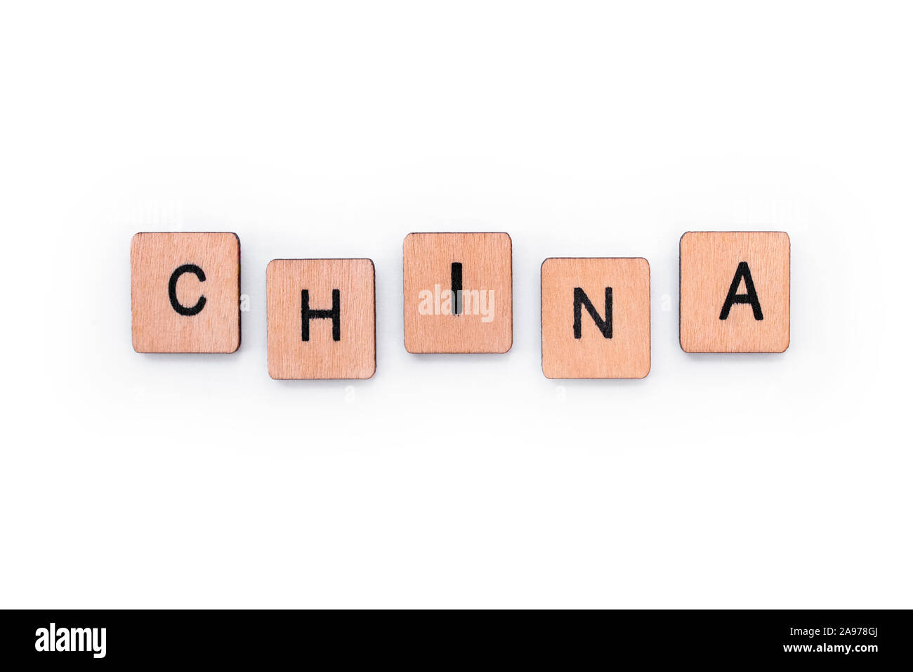 The word CHINA, spelt with wooden letter tiles over a white background ...
