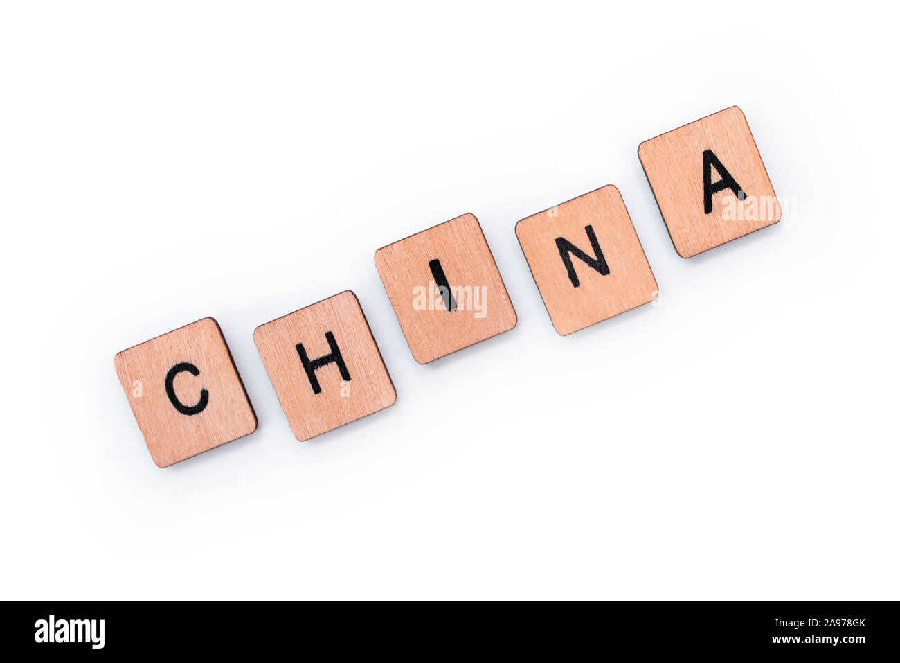 The word CHINA, spelt with wooden letter tiles over a white background ...