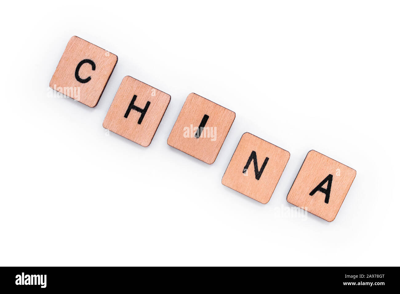 The word CHINA, spelt with wooden letter tiles over a white background ...