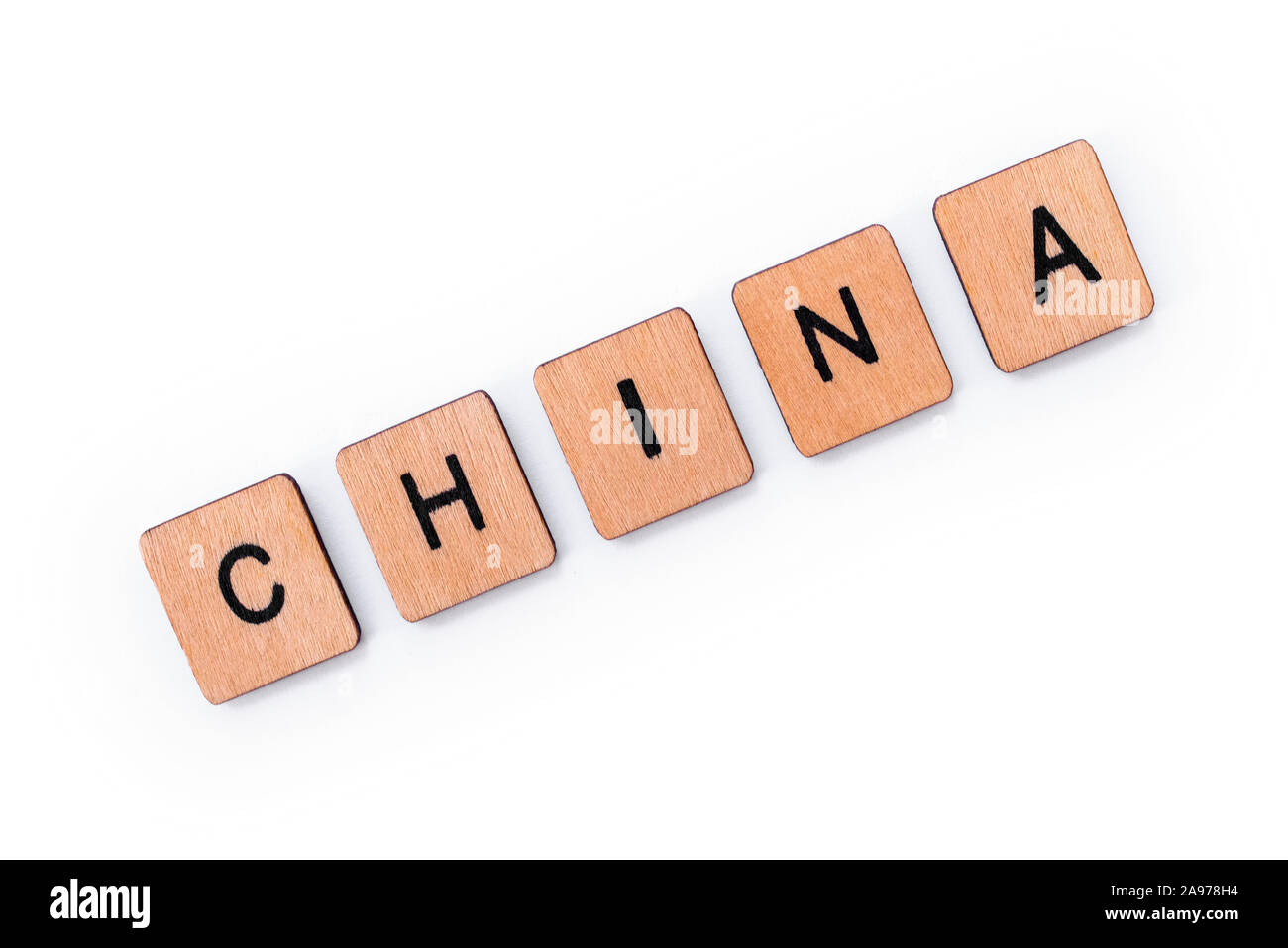 The word CHINA, spelt with wooden letter tiles over a white background ...