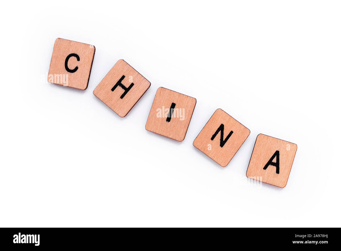 The word CHINA, spelt with wooden letter tiles over a white background ...