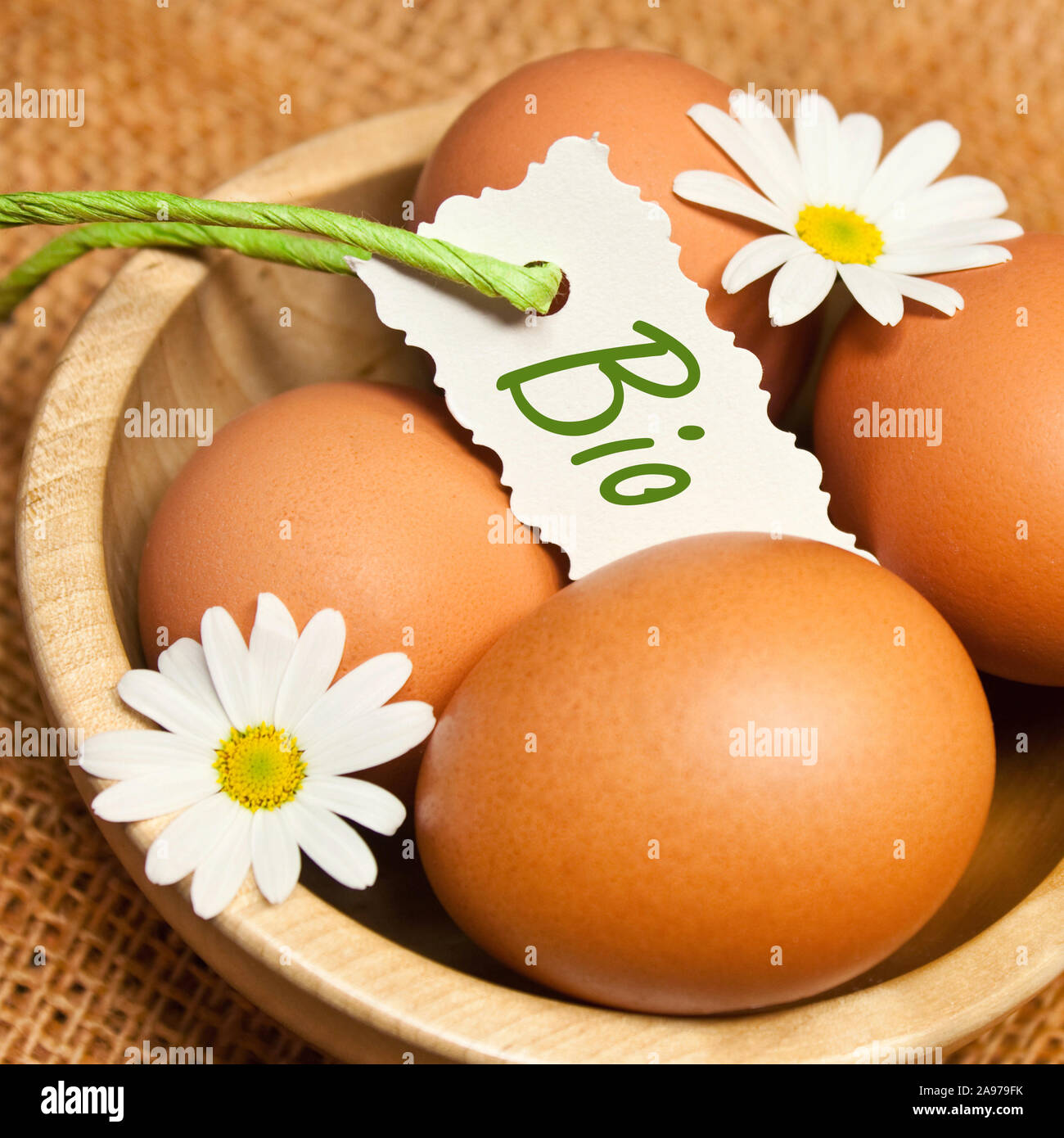 Brown and eggs in wooden bowl with bio label close up Stock Photo - Alamy