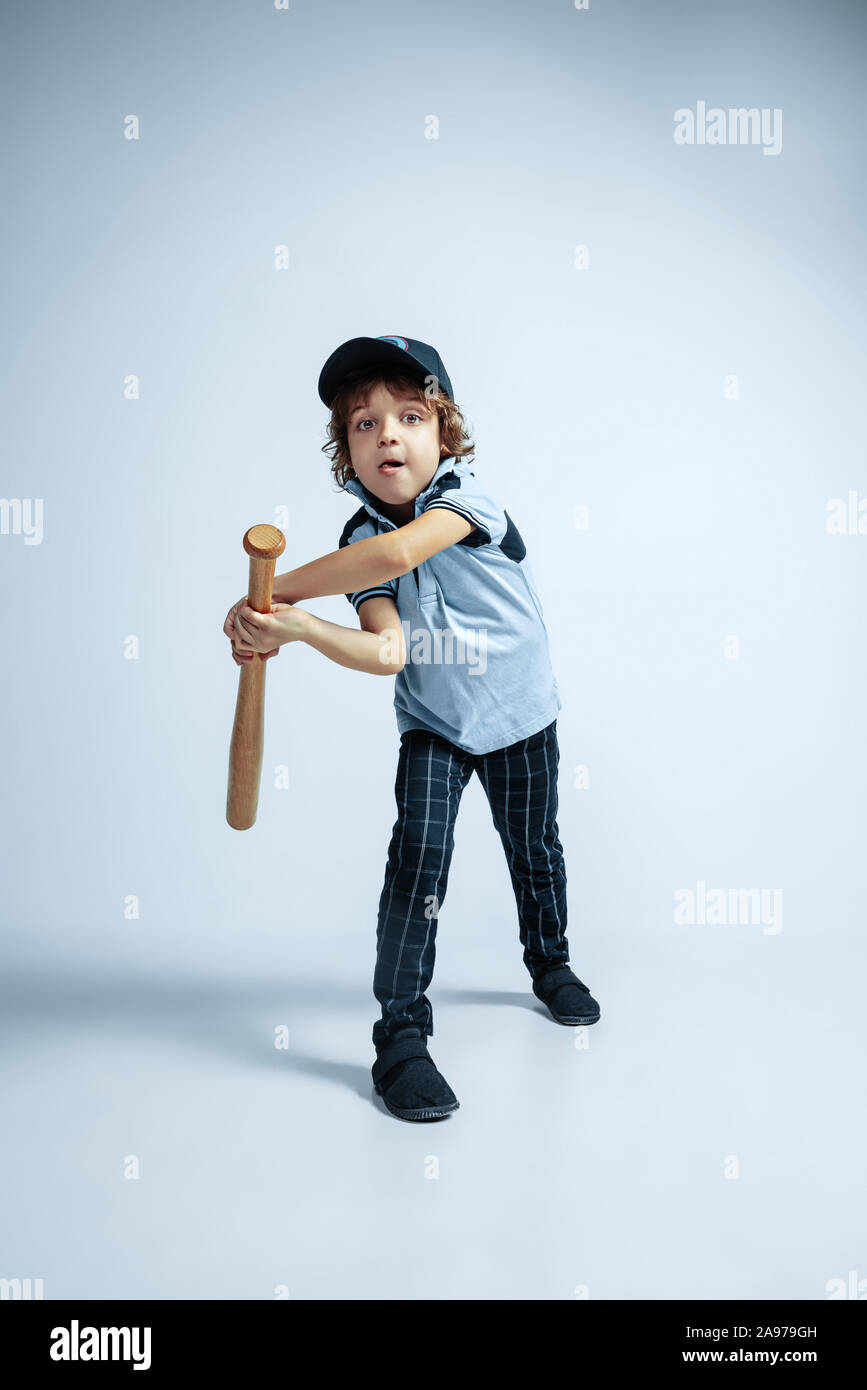 Pretty young curly boy in casual clothes on white studio background ...