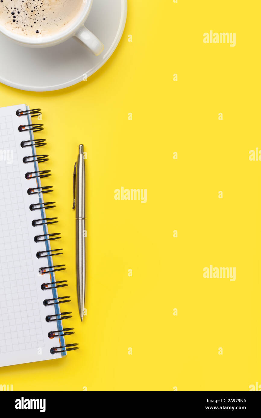 Office yellow workplace backdrop with coffee cup and supplies. Flat lay ...
