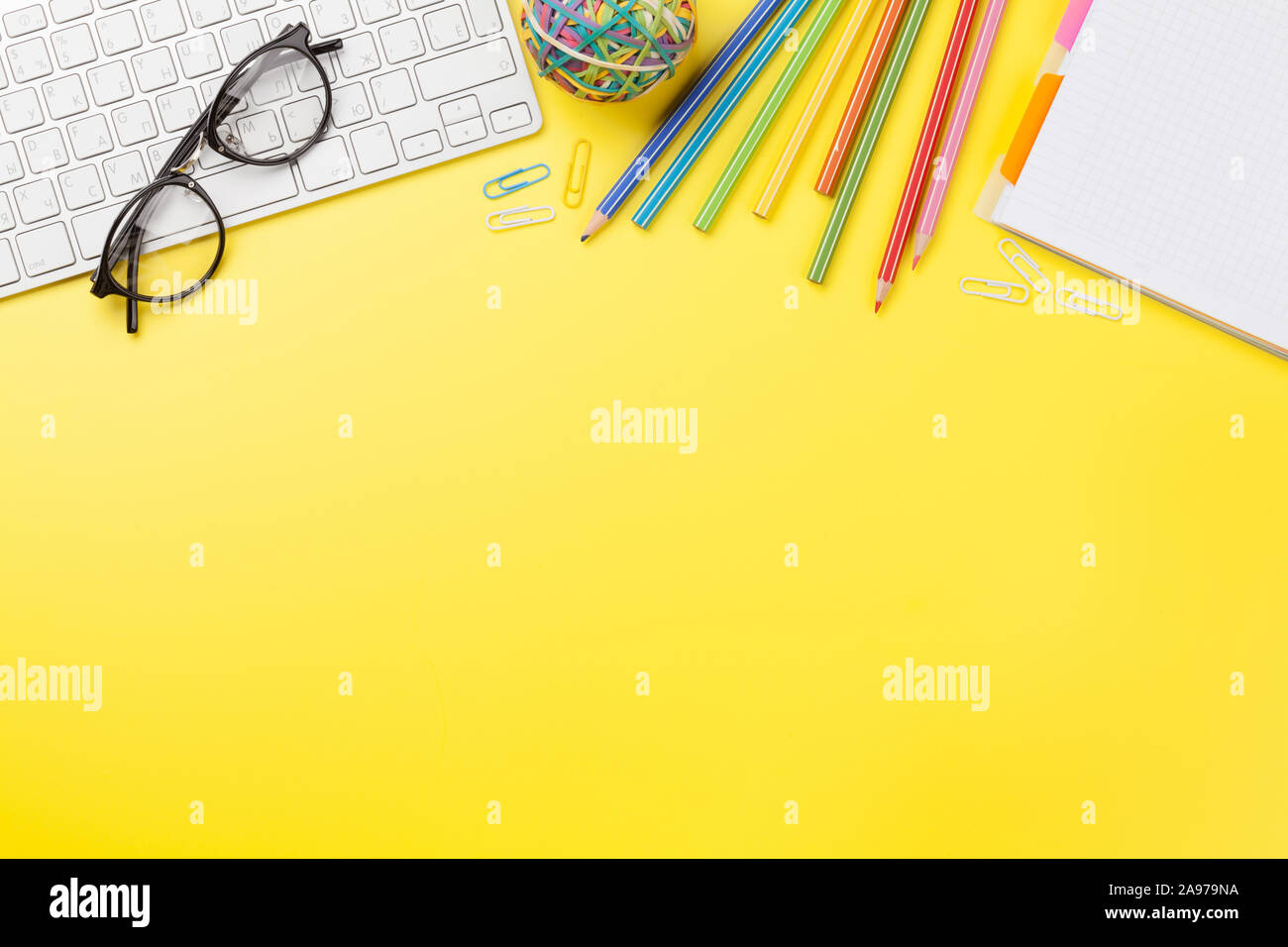 Office yellow workplace backdrop with supplies and computer. Flat lay ...