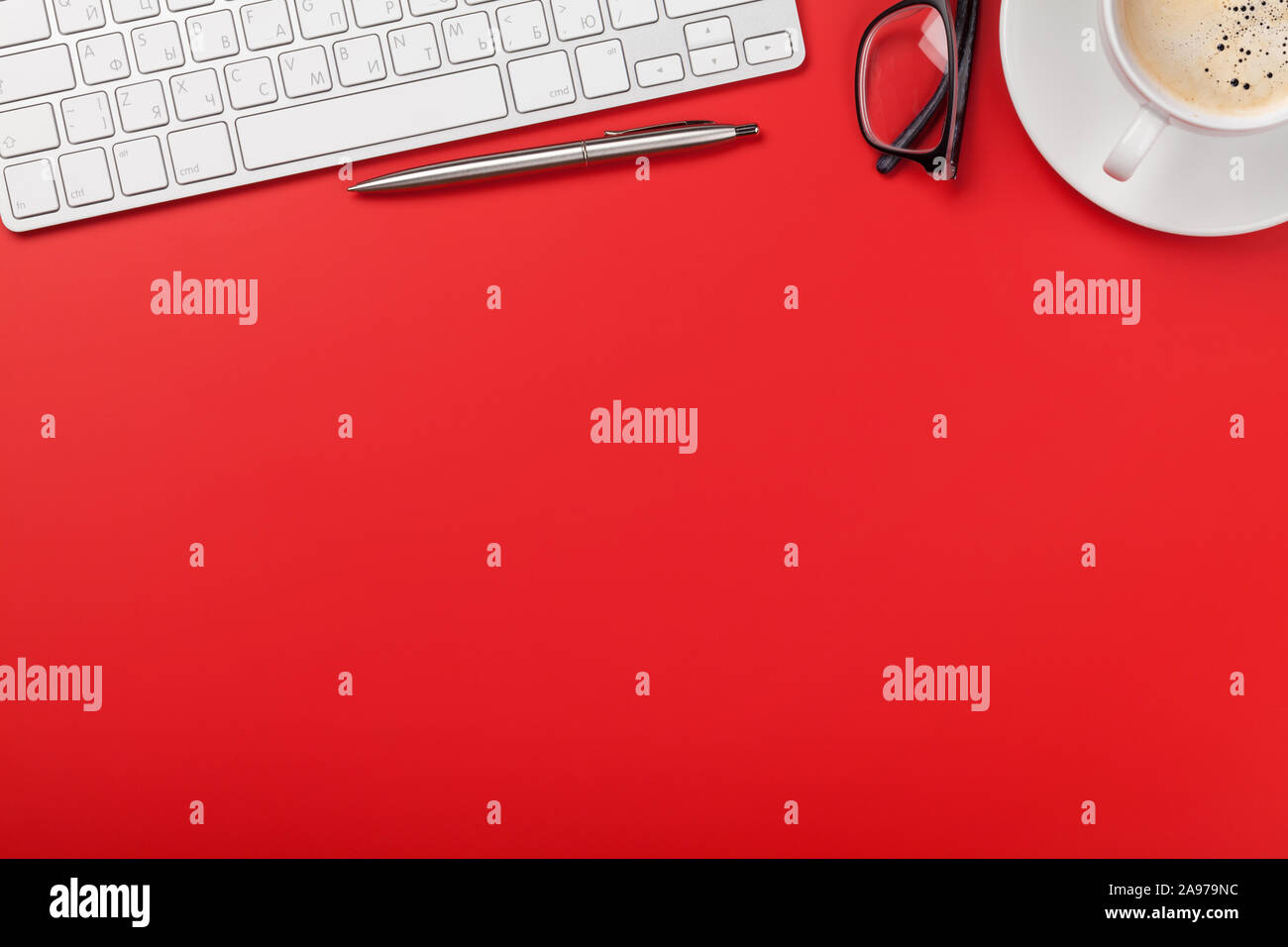 Office red workplace backdrop with coffee cup, supplies and computer ...