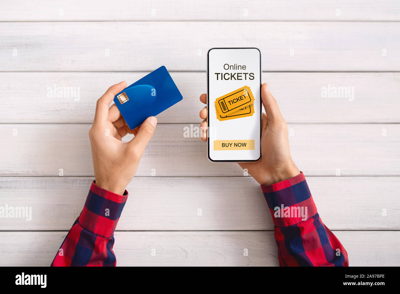 Man buying event tickets with app on smartphone and credit card, white ...