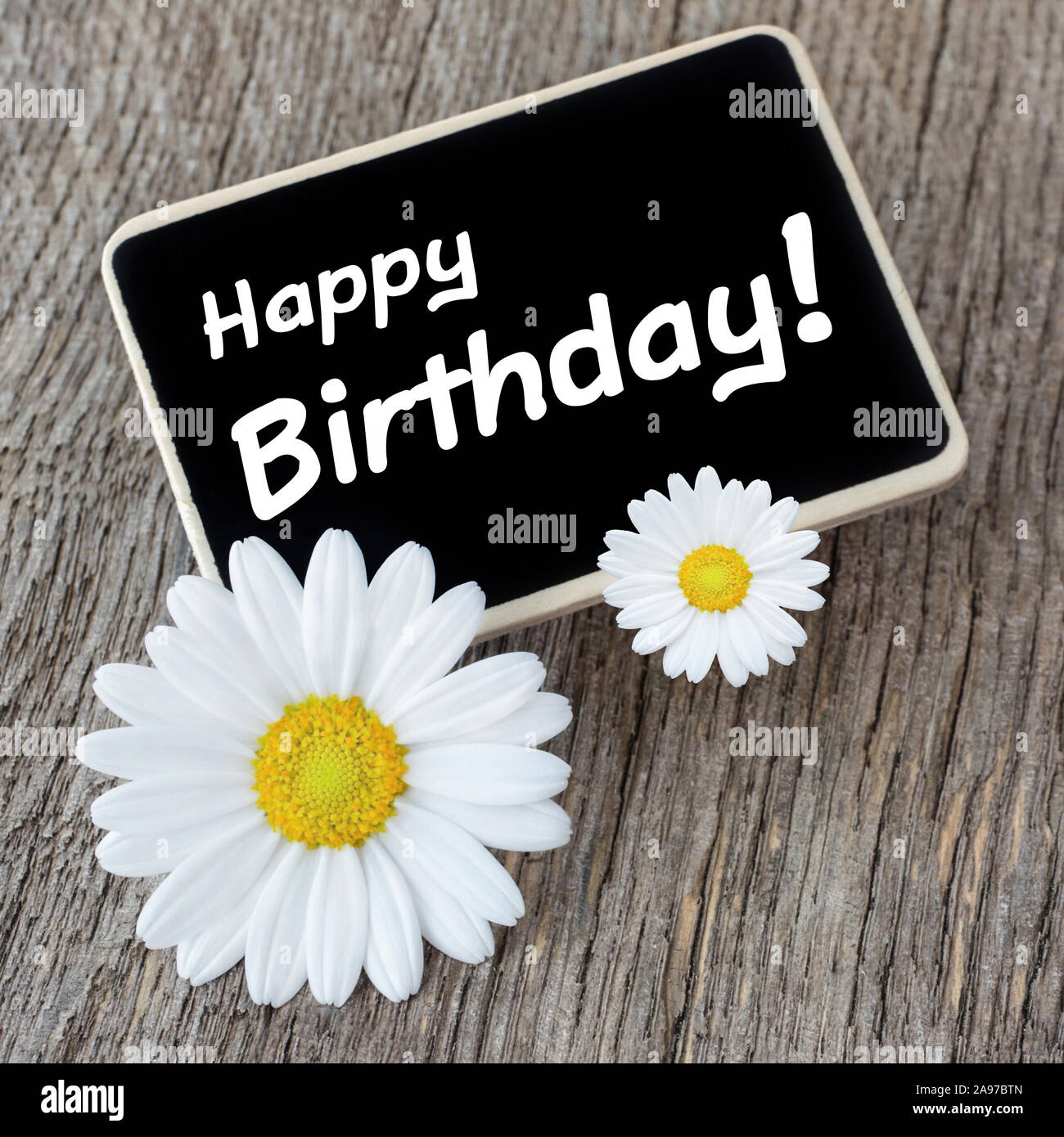 Happy Birthday board and flowers Stock Photo - Alamy