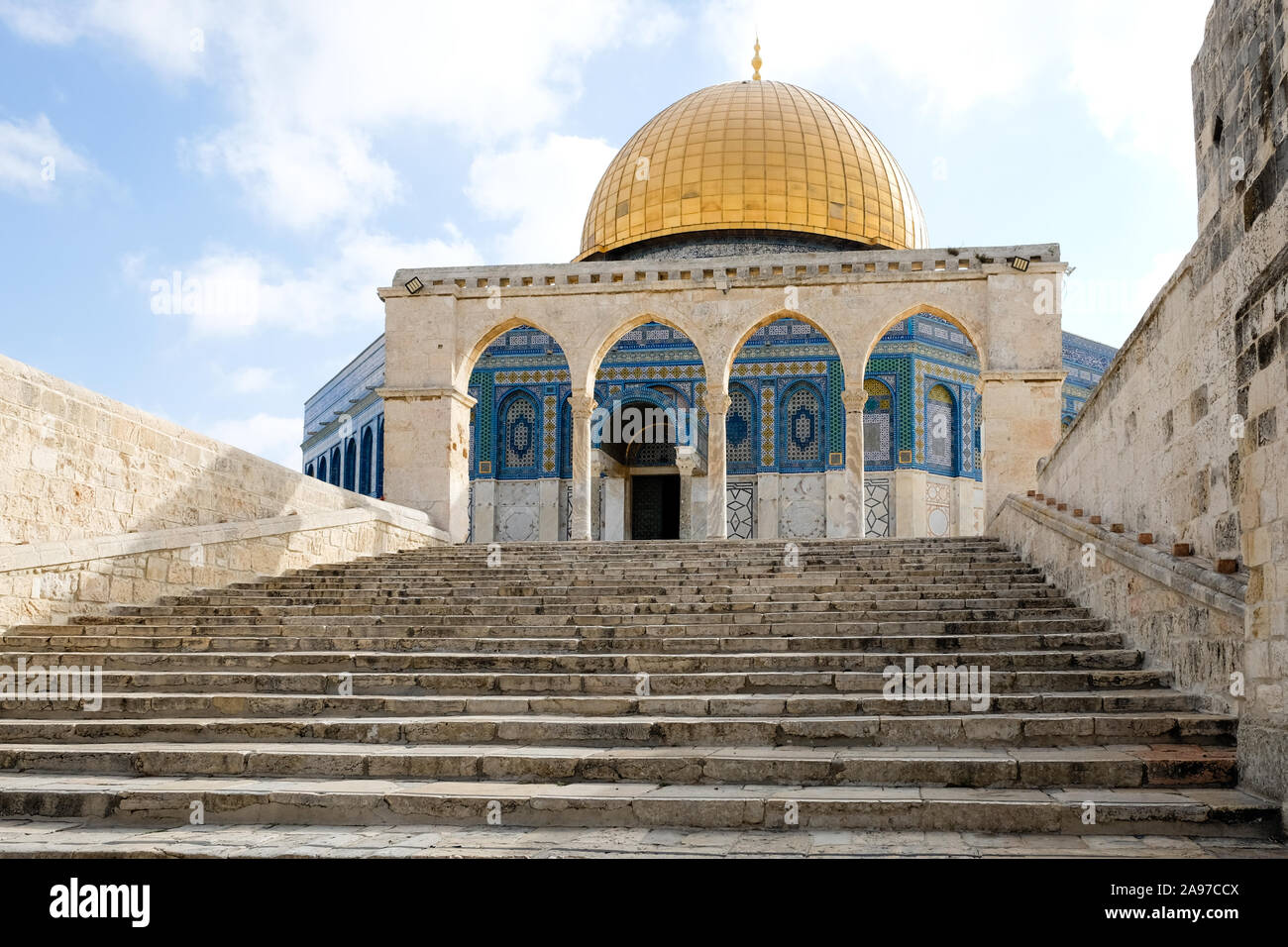 Stone stairs leading up through arches to the gold topped, sacred Dome ...