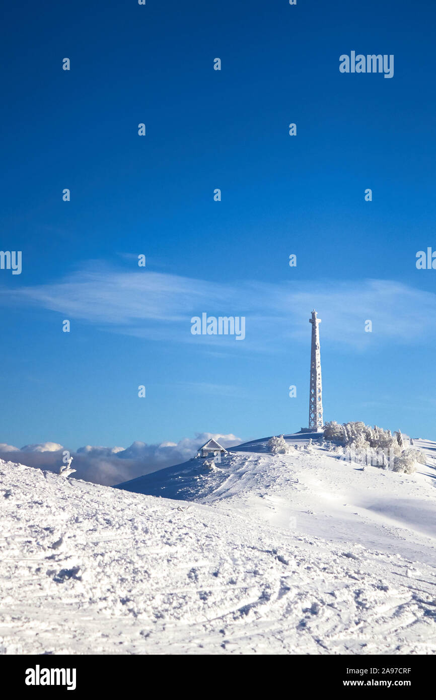 Icy cellular base station antenna covered with snow. Cell site tower on ...