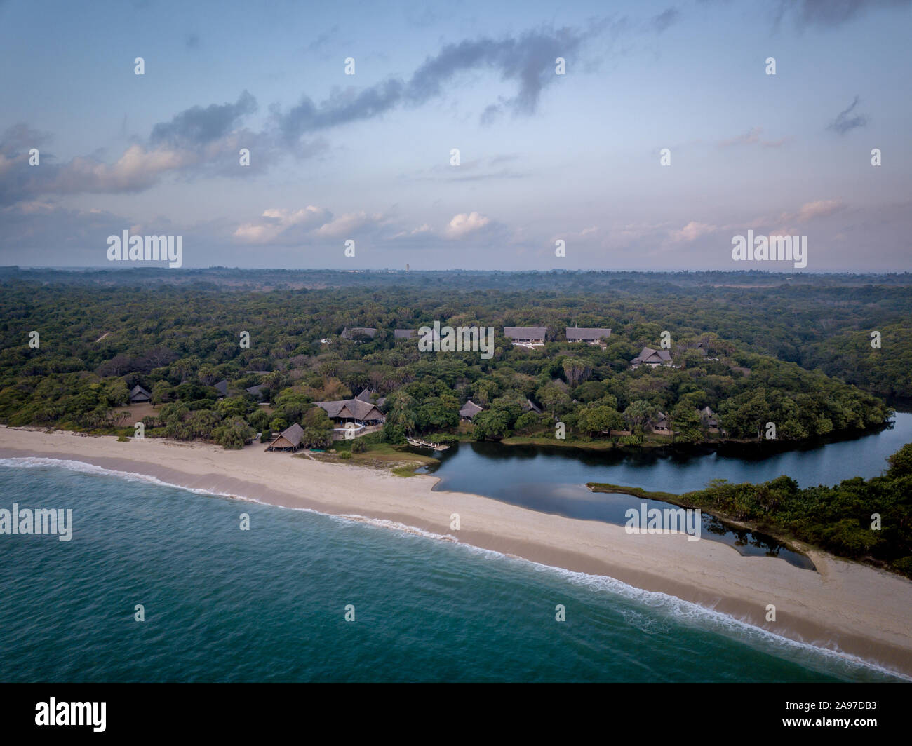 Traditional lodge in a coastal forest by a lagoon on the Indian ocean ...