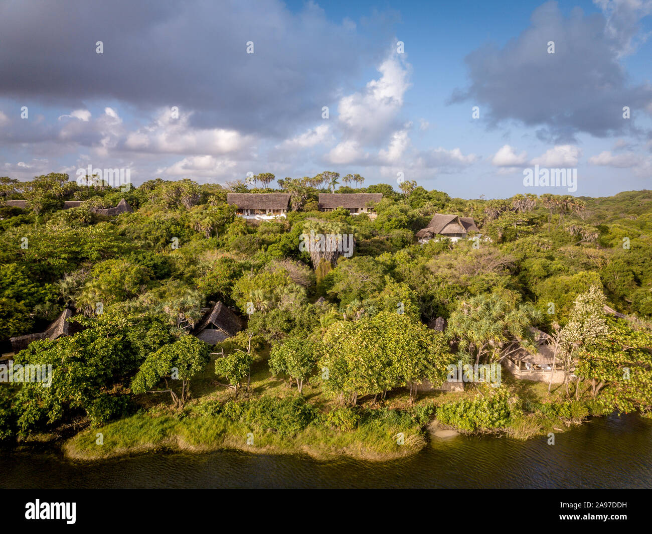 Traditional lodge in a coastal forest by a lagoon on the Indian ocean ...