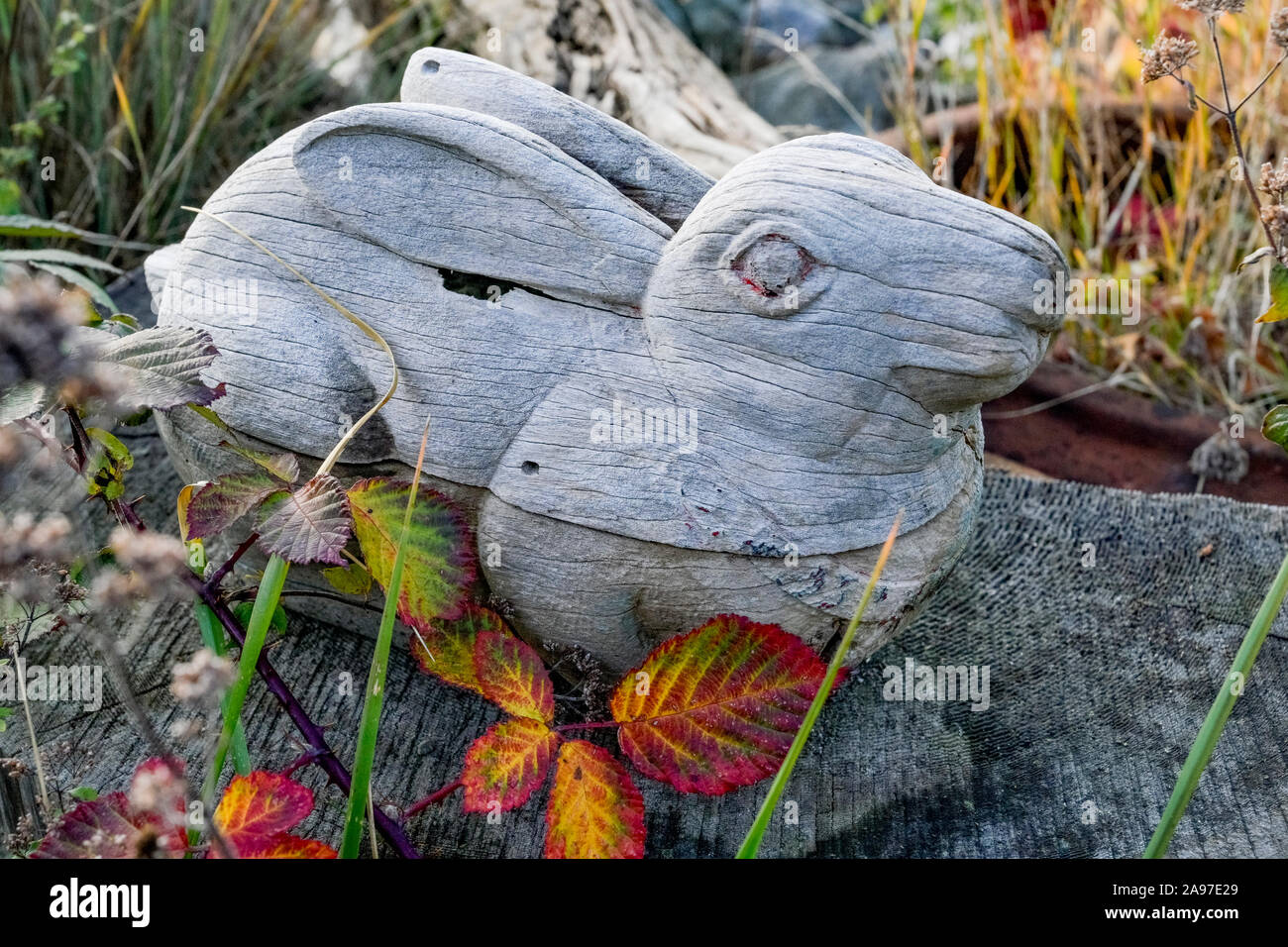 rabbit wood carving in garden Stock Photo - Alamy