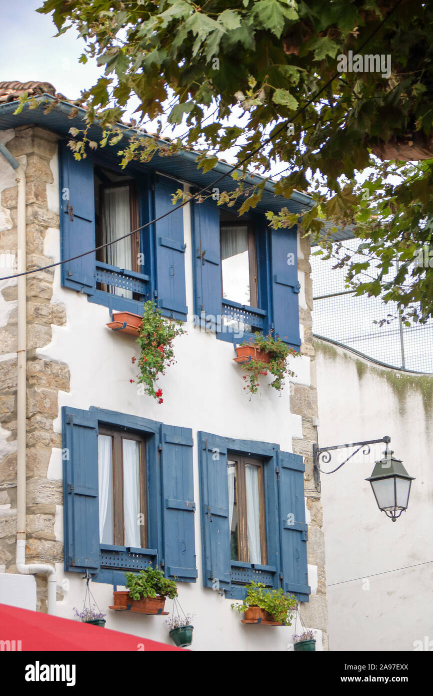 nice facade with blue windows on a typical house of saint jean de luz ...