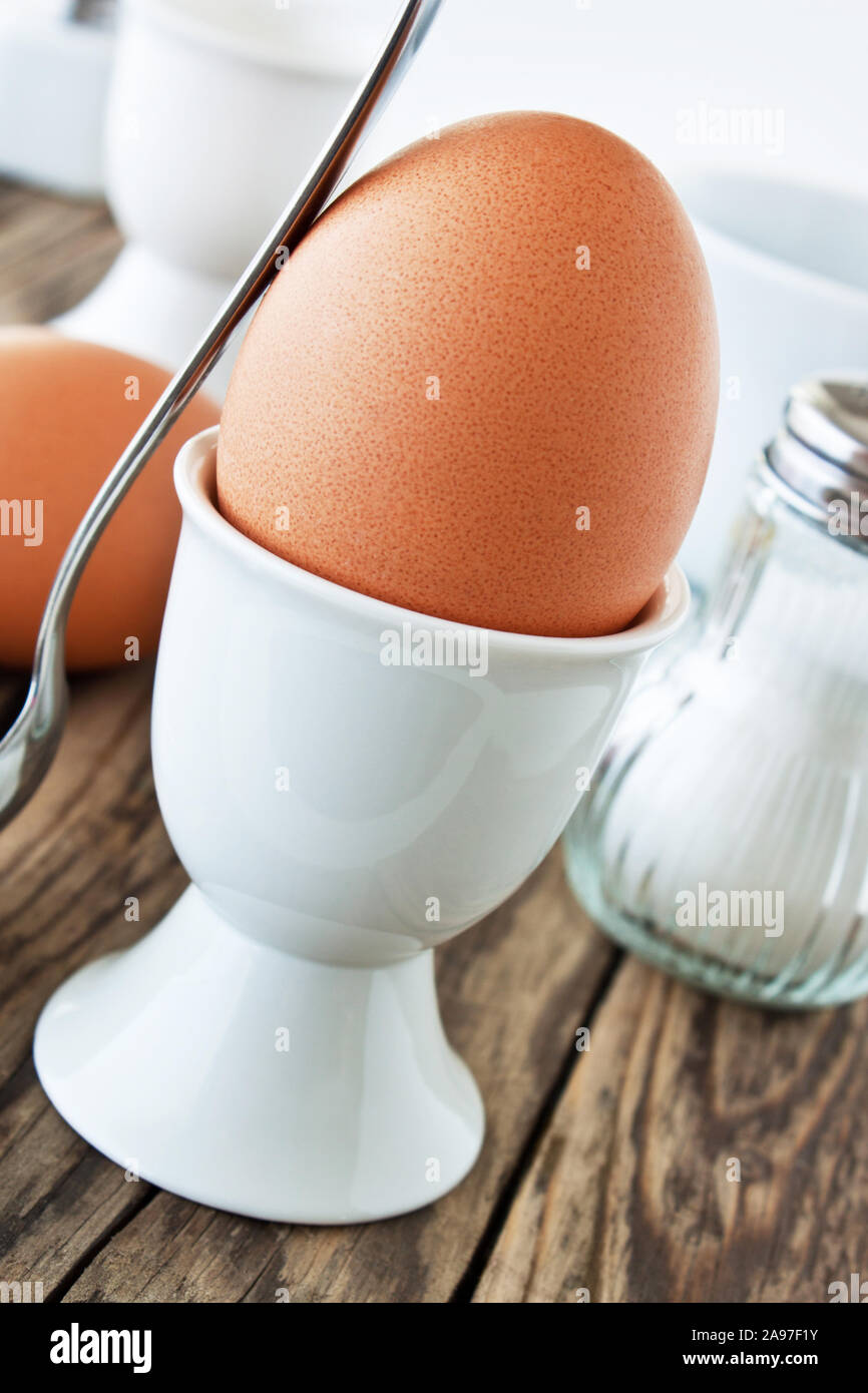 Boiled egg and egg cup with spoon Stock Photo - Alamy
