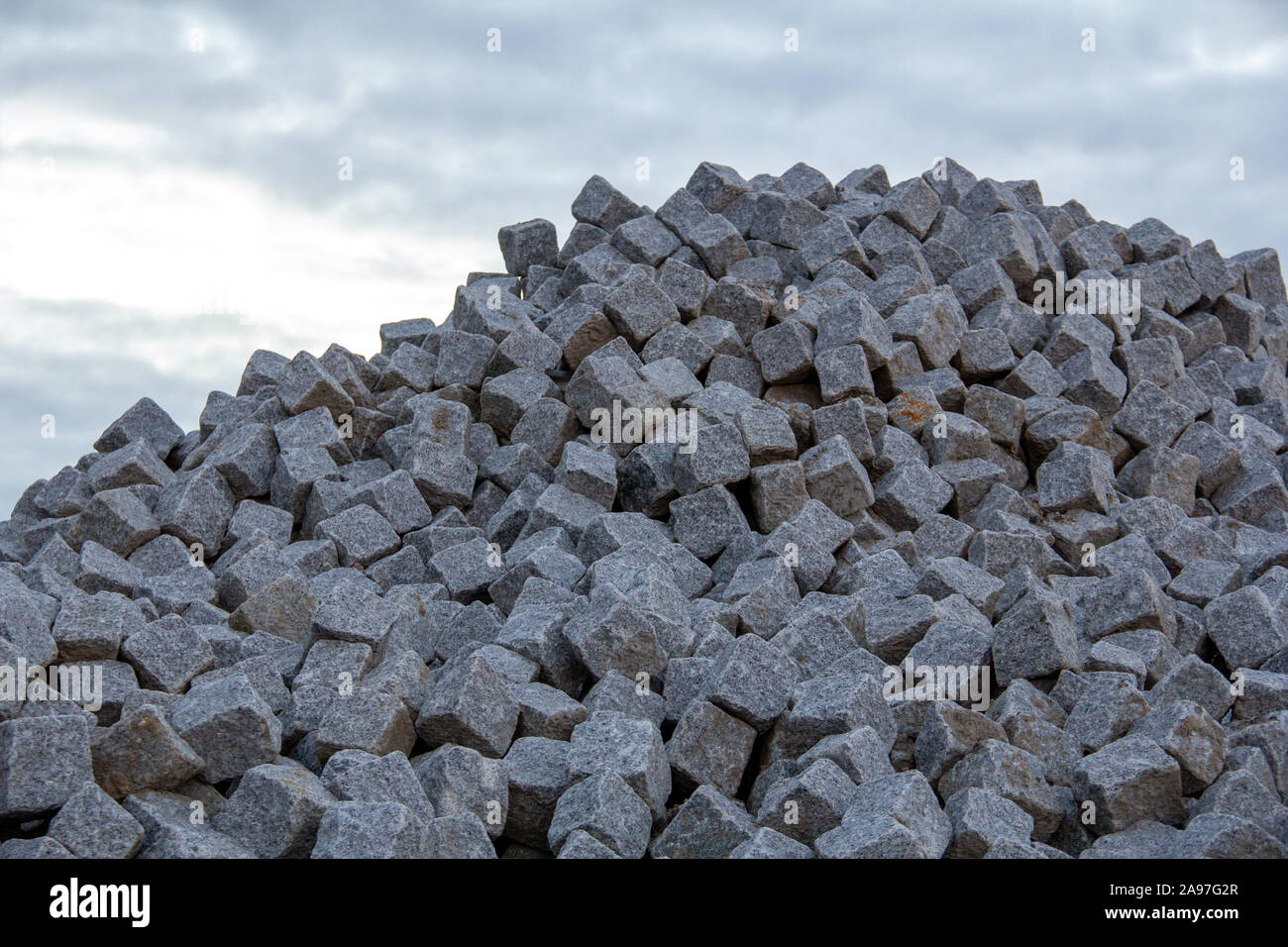 A big pile of European square cobblestones has been placed on a ...