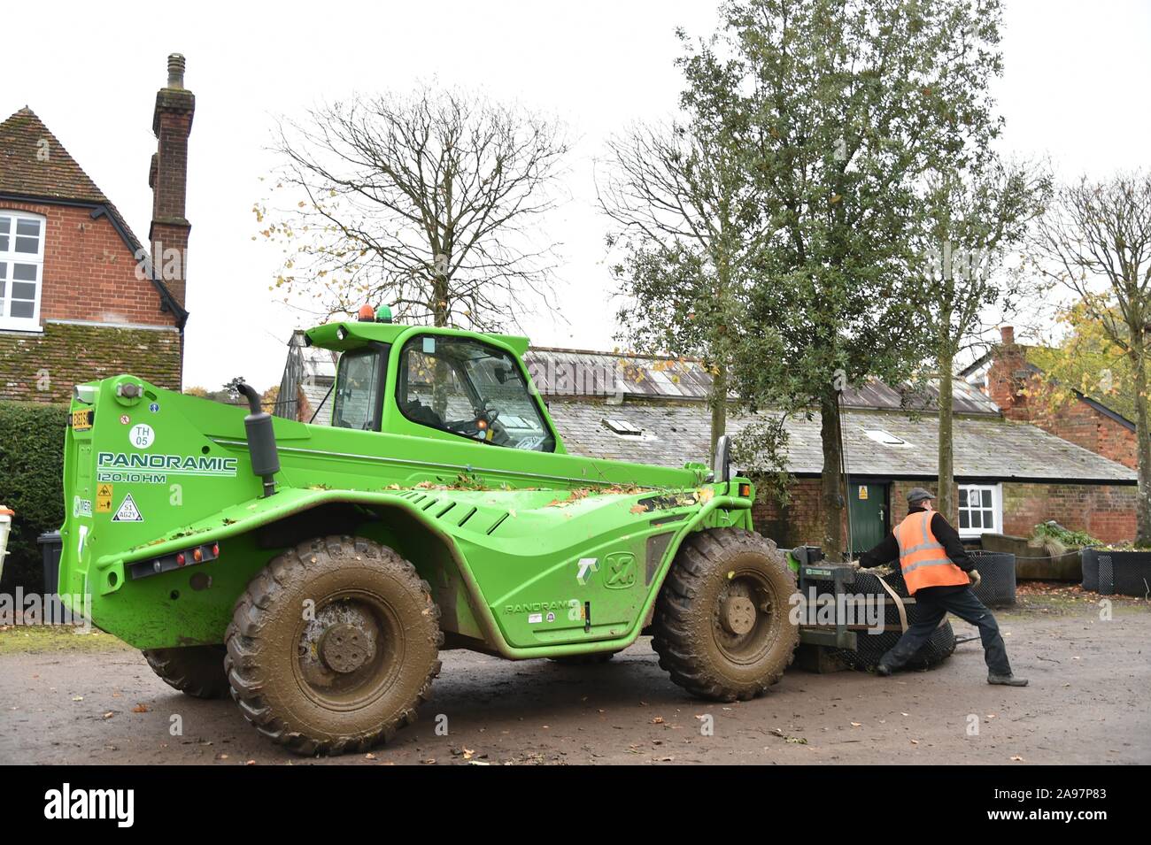Tree nursery worker using heavy lifting equipment Stock Photo - Alamy