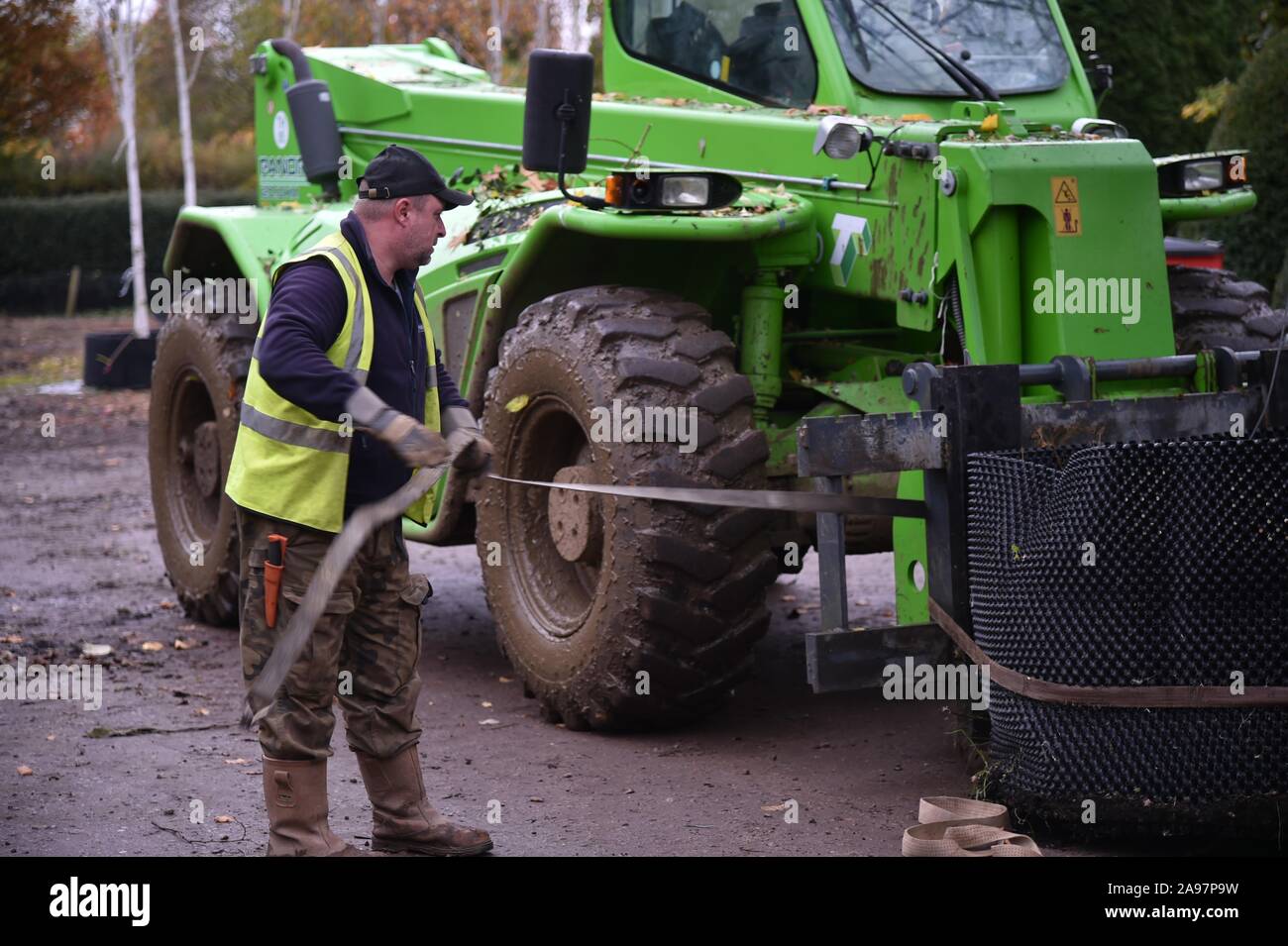 Tree nursery worker using heavy lifting equipment Stock Photo - Alamy