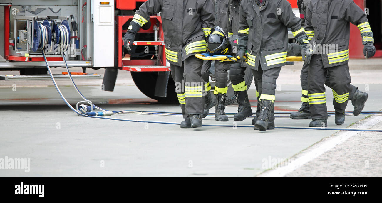 four firemen stretcher bearer after the road accident on the street and ...