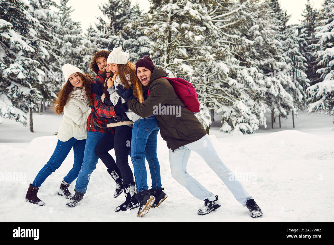 Funny friends playing in the park in winter Stock Photo - Alamy