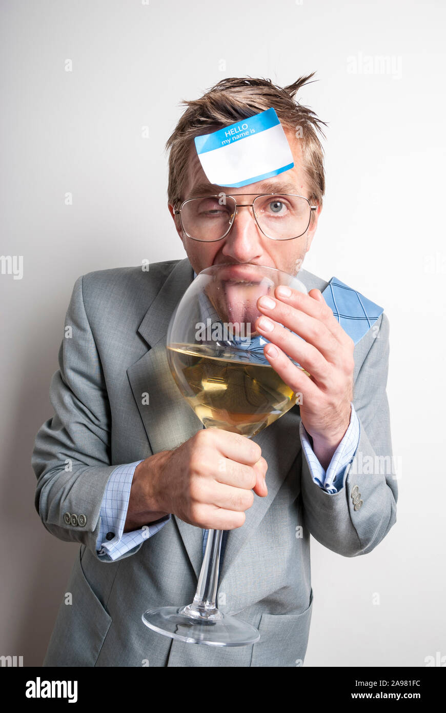 Drunk office worker with a name tag stuck to his forehead licking an ...