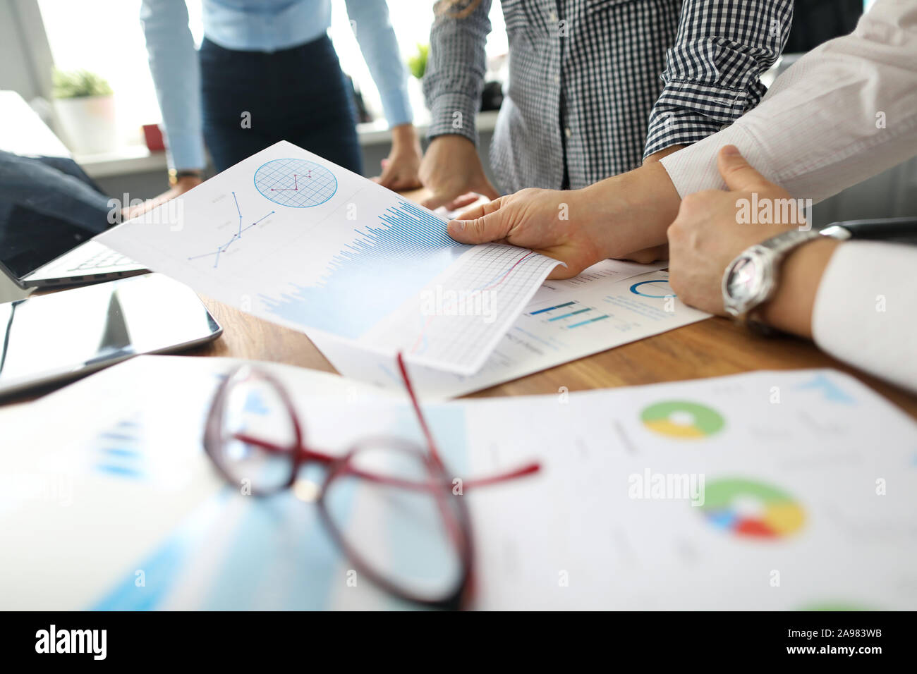 Manager holding in hand financial graph paper Stock Photo - Alamy