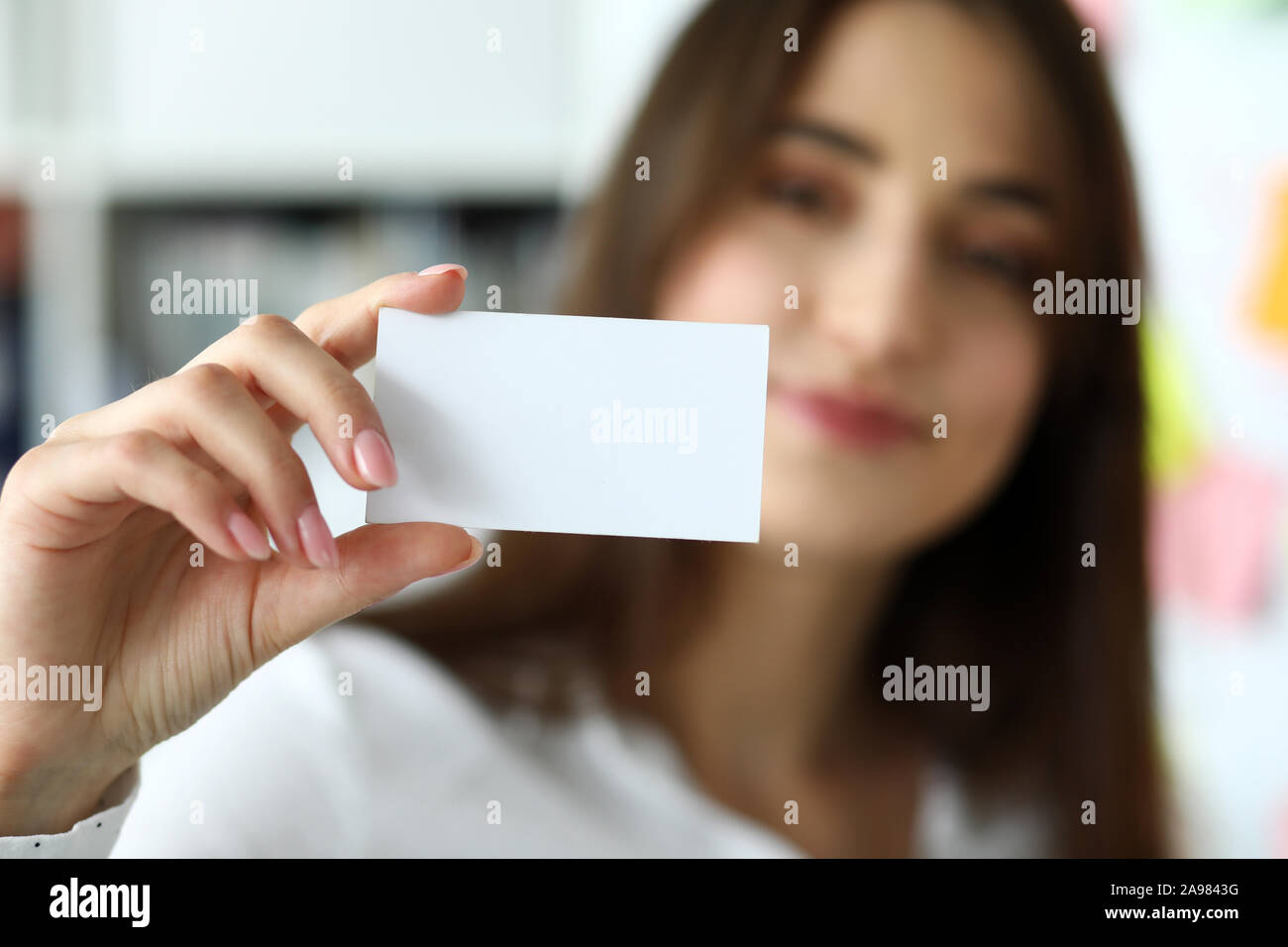 Female arm in suit give blank calling card to visitor Stock Photo - Alamy