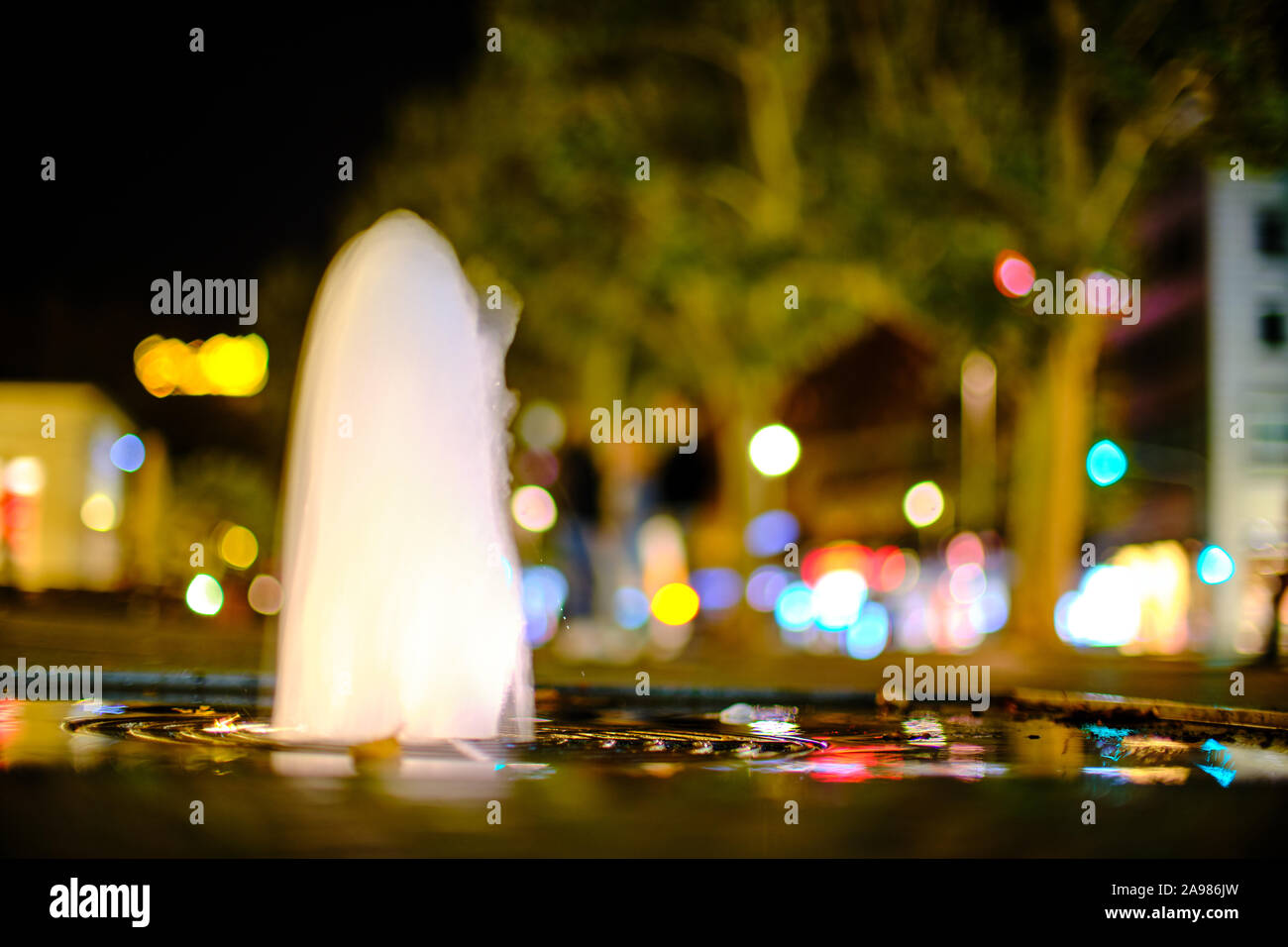 Illuminated water in front of "Elisenbrunnen" fountain in the heart of ...