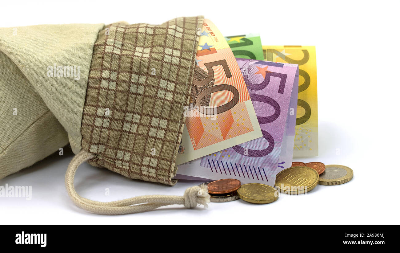 Banknotes and coins in a bag in front of a white background Stock Photo ...