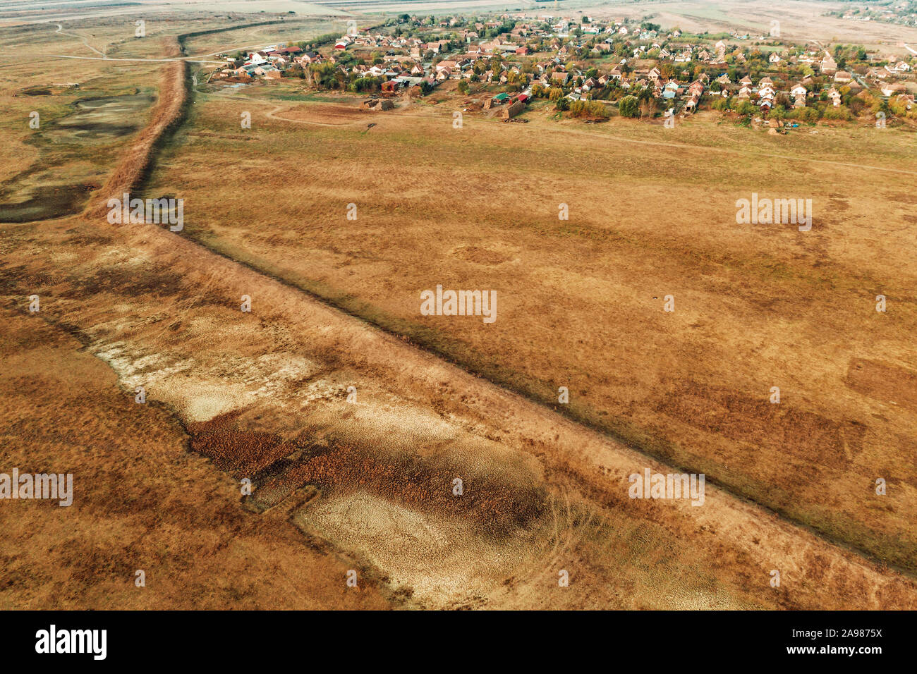 Aerial view of embankment protecting village from river overflowing and ...
