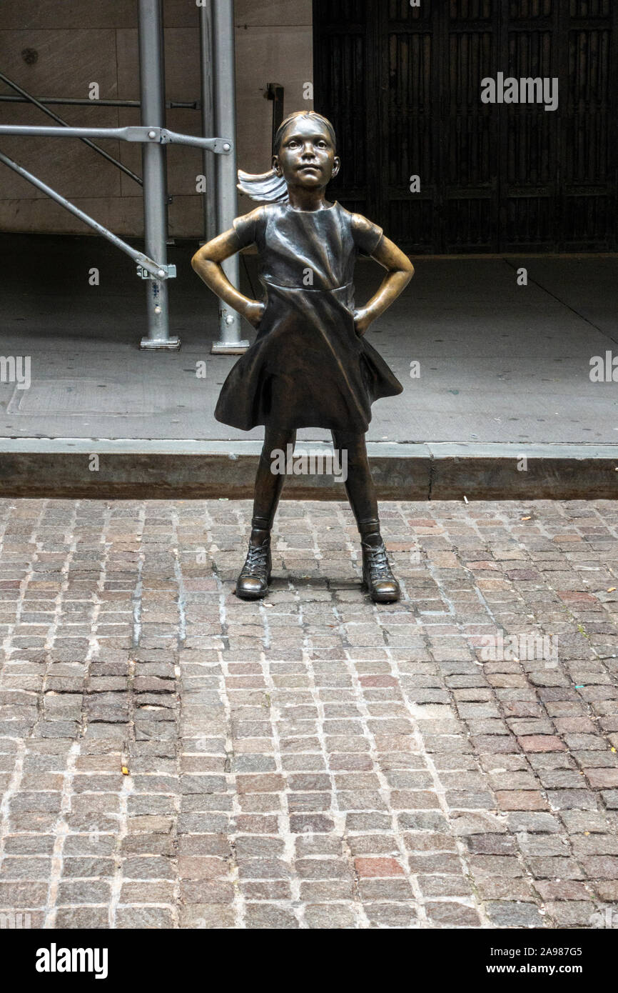 Fearless Girl sculpture facing Stock Exchange building on Wall St ...