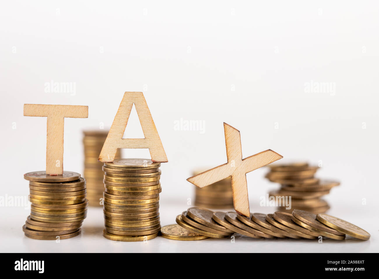 TAX inscription made of wooden letters on coin posts. Symbol of tax ...