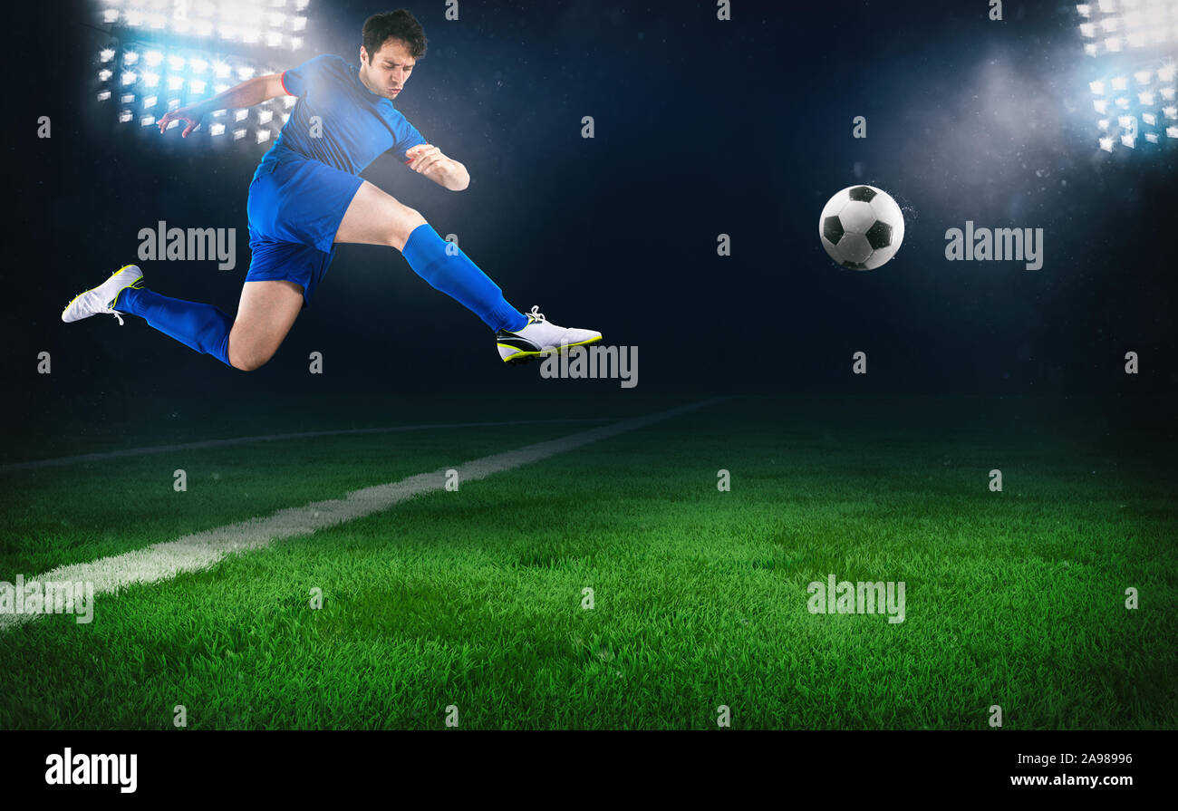 Football scene at night match with a soccer player running to kick the ...