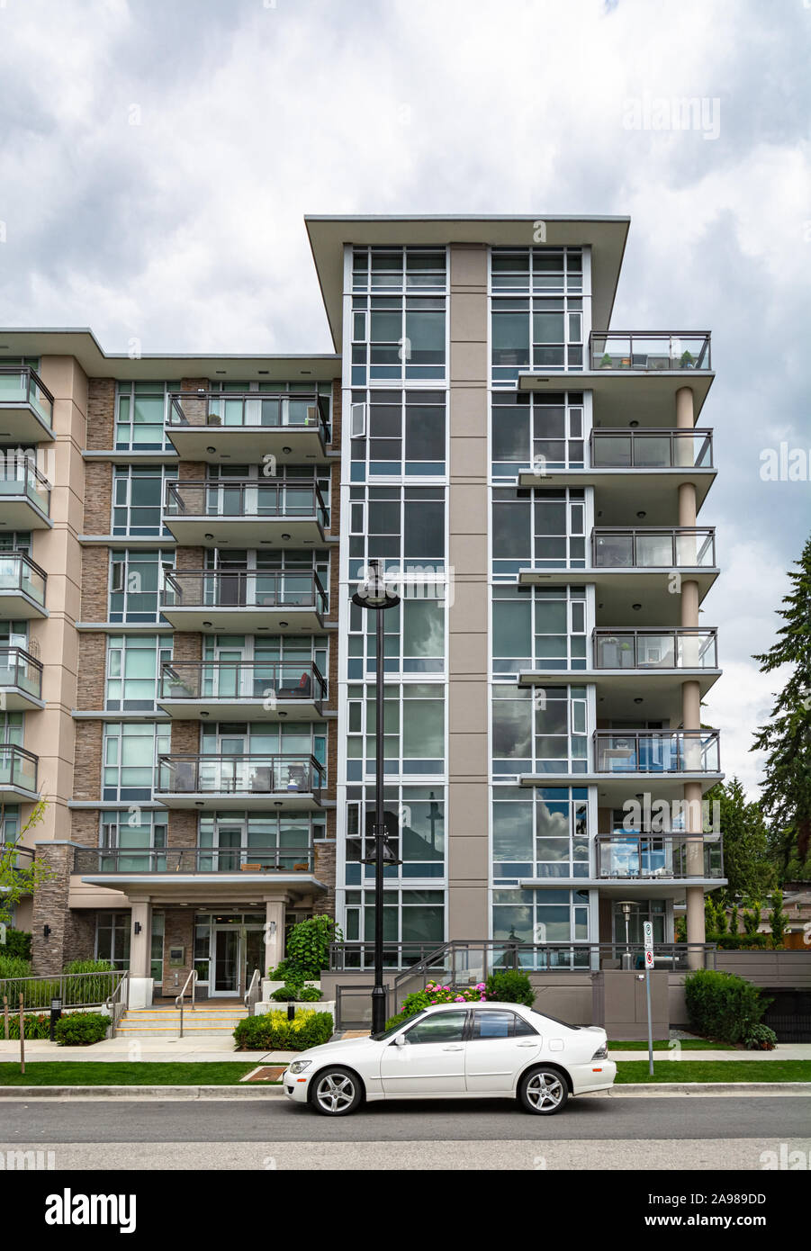 New residential low-rise building with cars parked on the street Stock ...