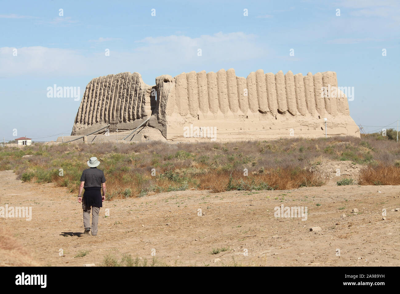 Tourist walking towards the Great Kyz Kala at Ancient Merv in ...