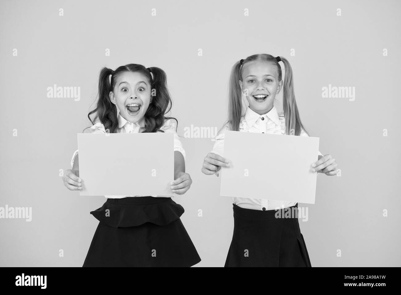 Genius advertising and marketing. Happy genius children holding blank ...