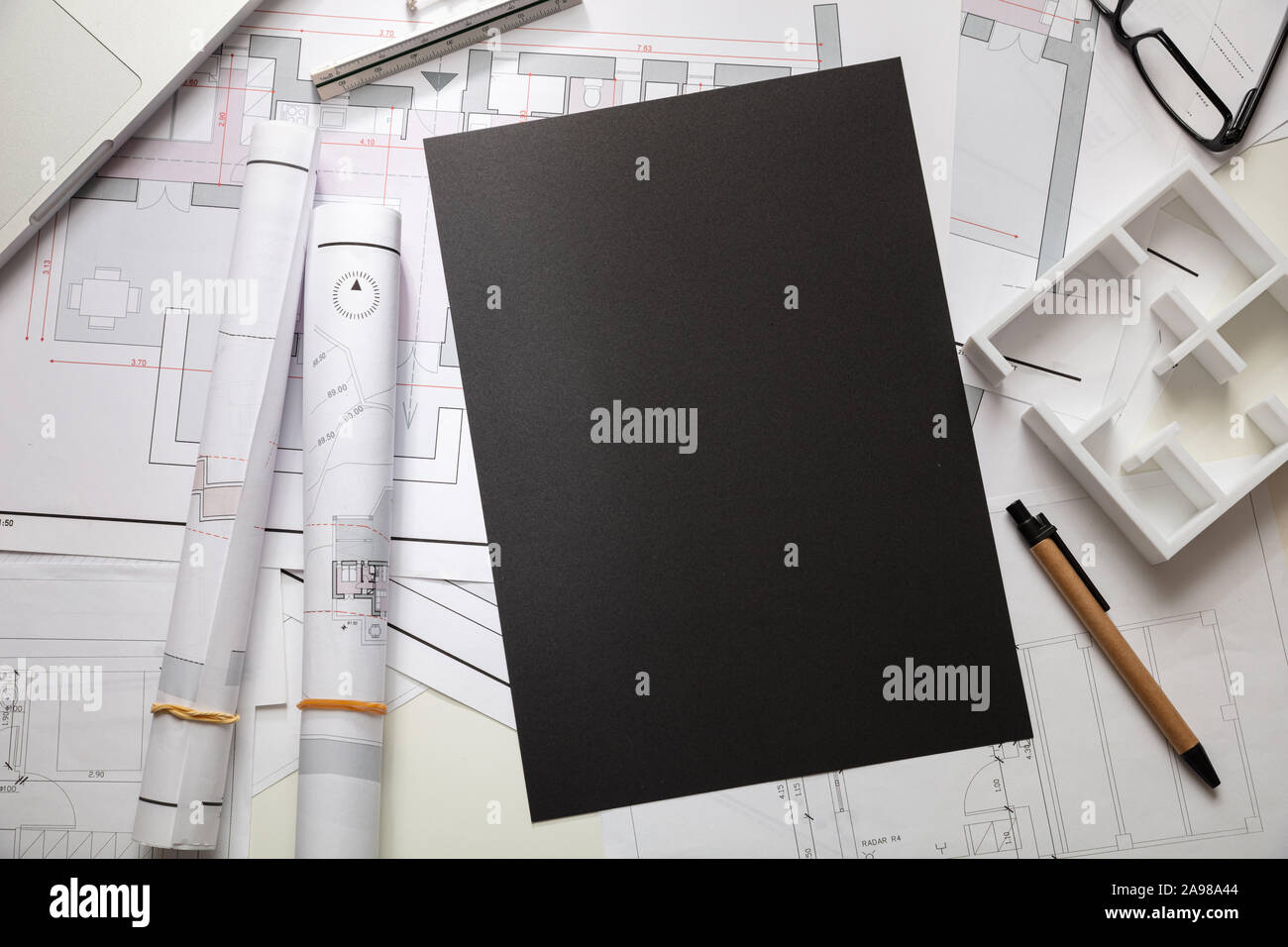 Architect engineer office desk. Blueprint plans, blank black carton ...