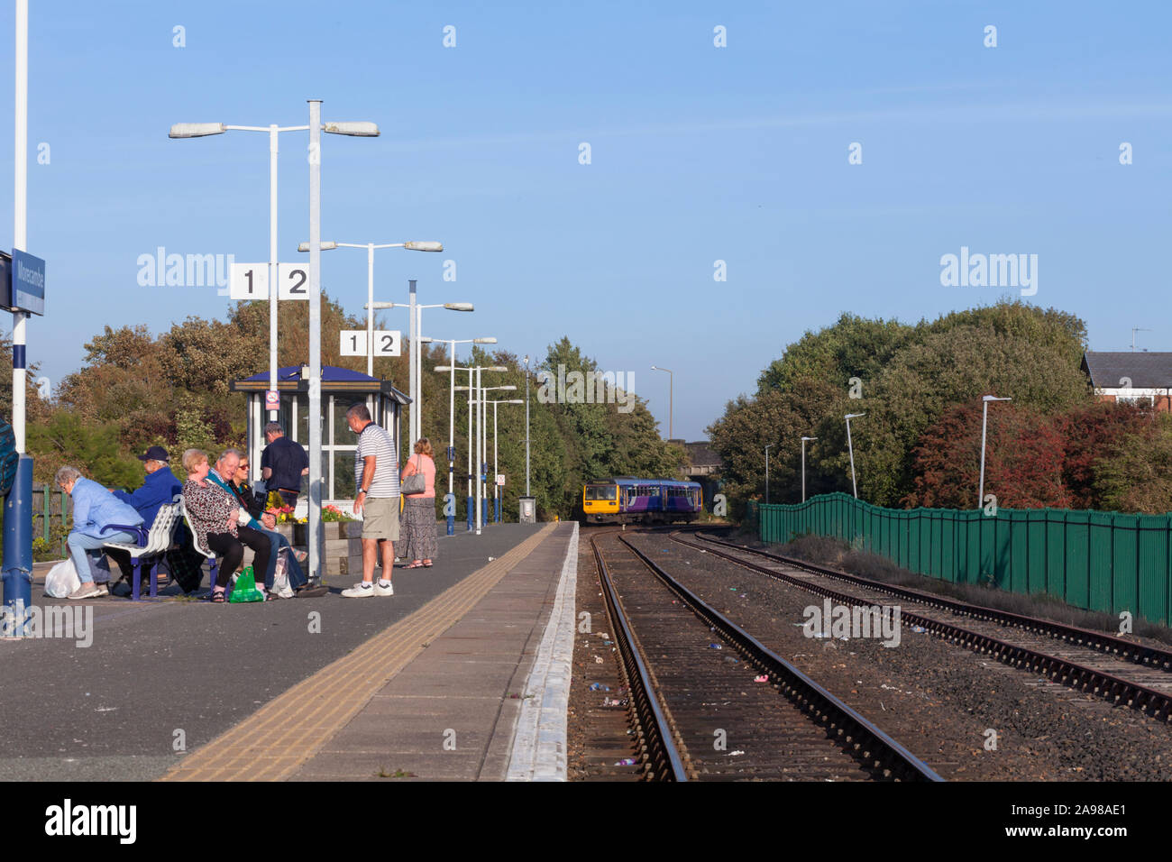 Arriva Northern Rail class 142 pacer train arriving at Morecambe railway station with rail ...