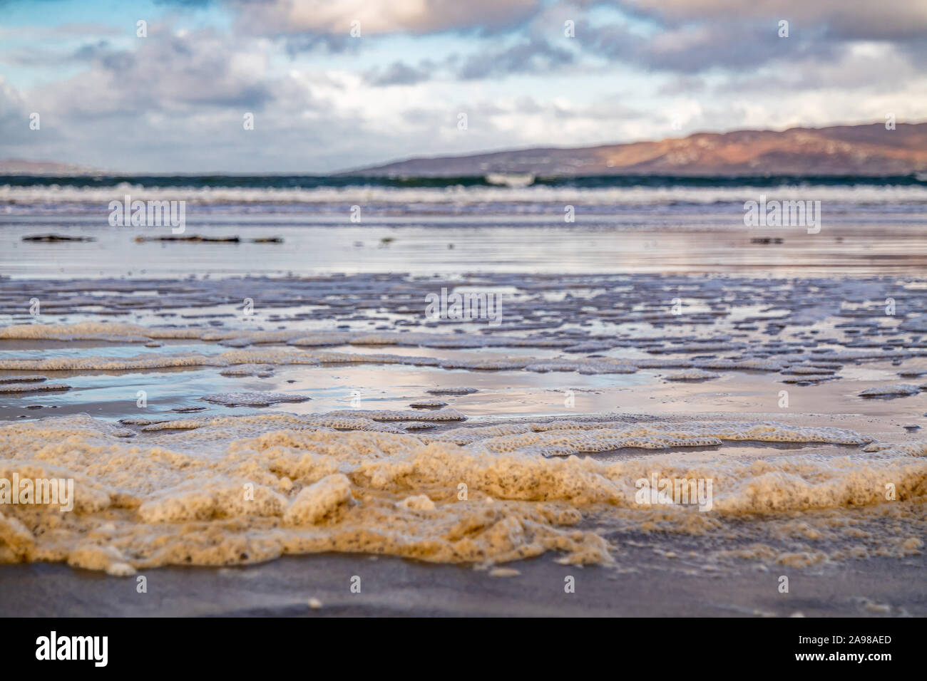 Sea foam on the beach on beach in County Doneal - Ireland Stock Photo ...