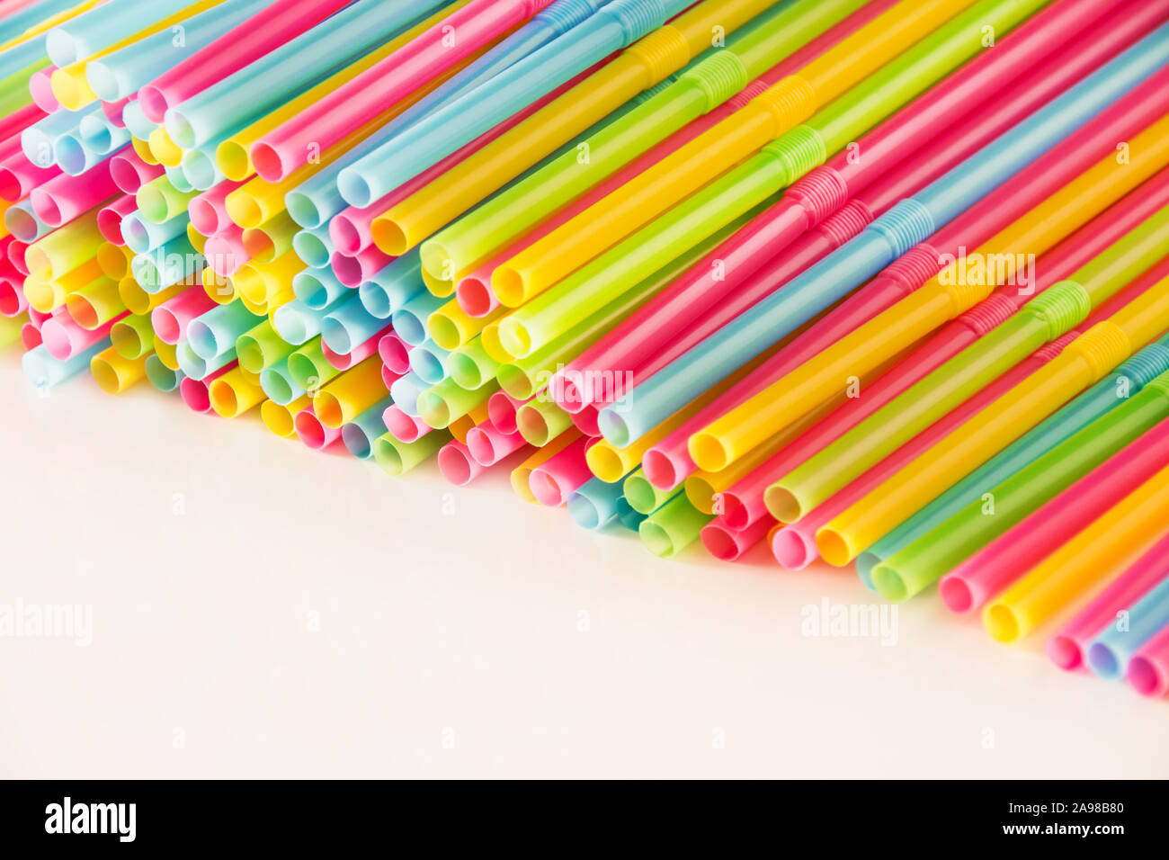 Colorful straws and white background Stock Photo - Alamy