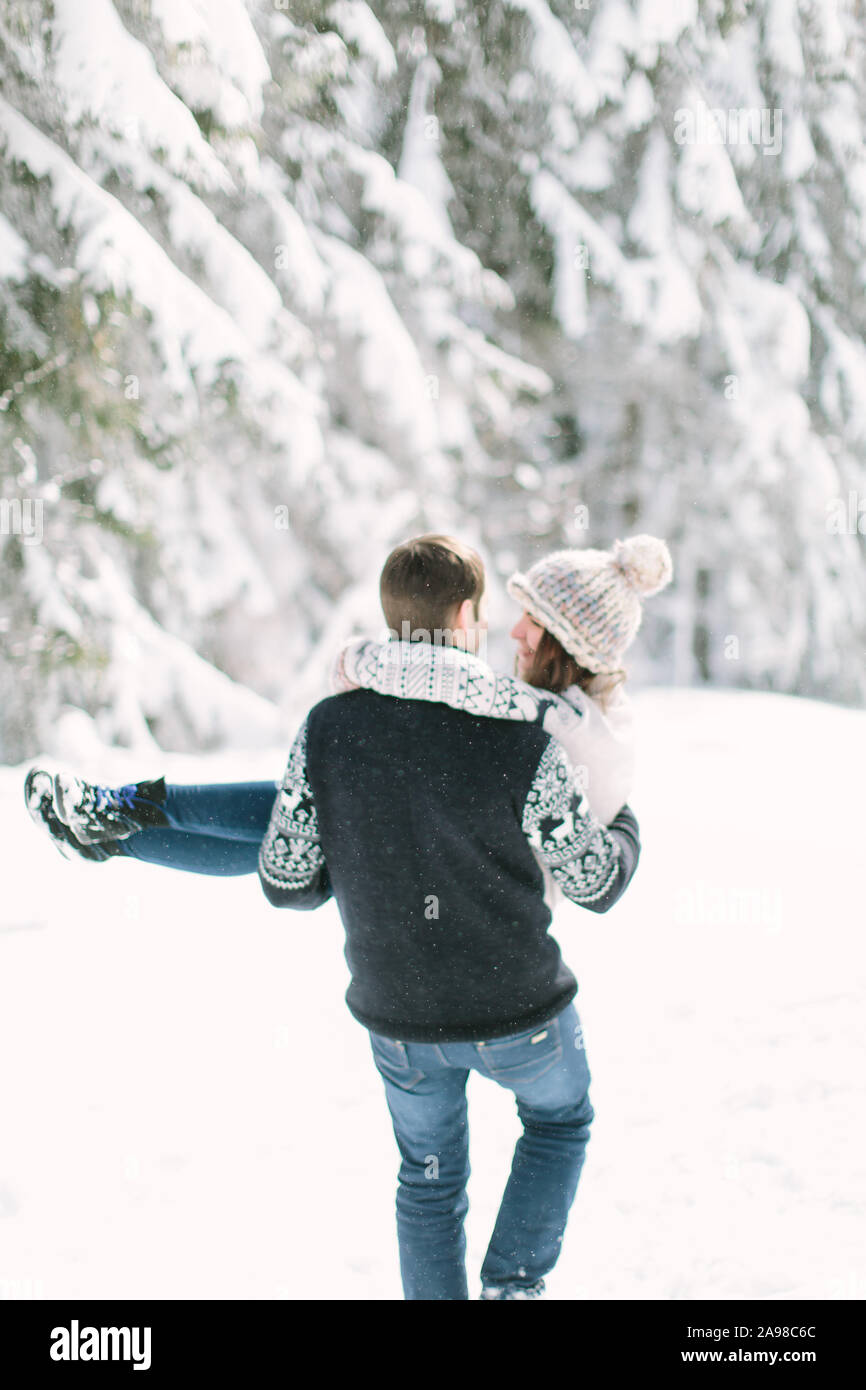 Winter fun couple playful together during winter holidays vacation ...