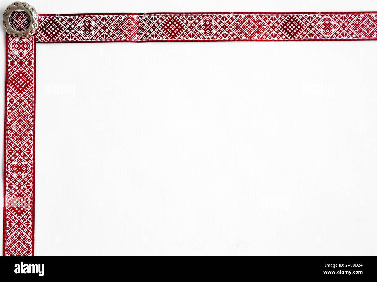 Red and white ribbon with ornament of Latvian signs and Latvian ...