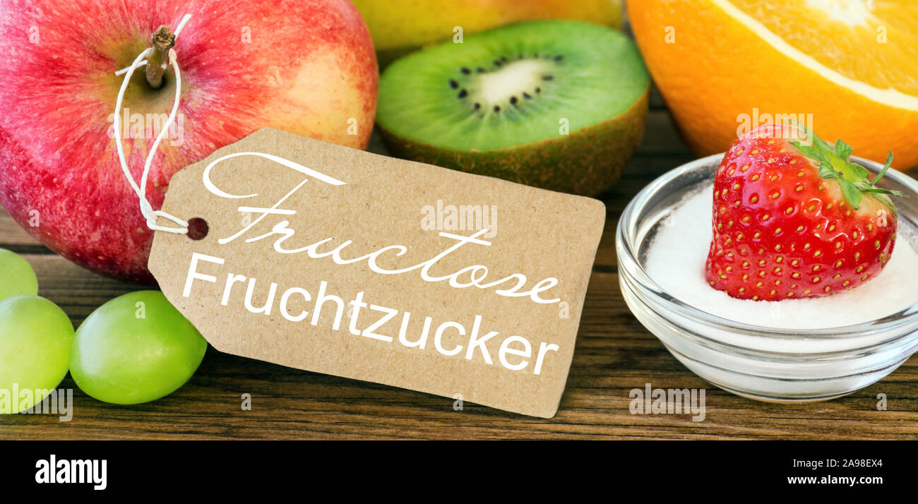 Fresh fruits with label German: Fructose Stock Photo - Alamy