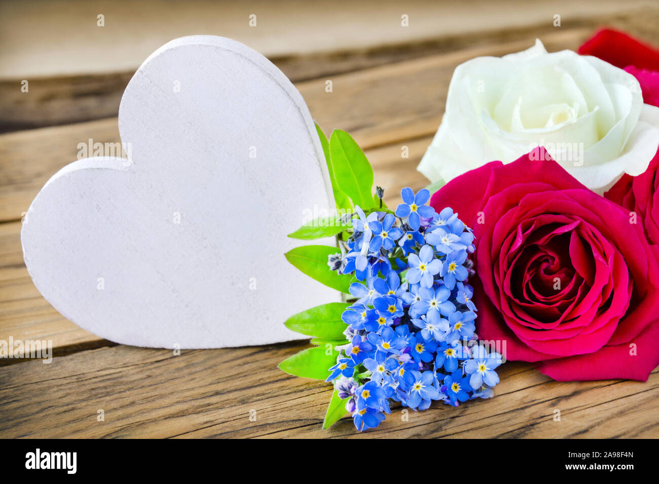 Forget-me-not flowers and red rose with heart Stock Photo - Alamy