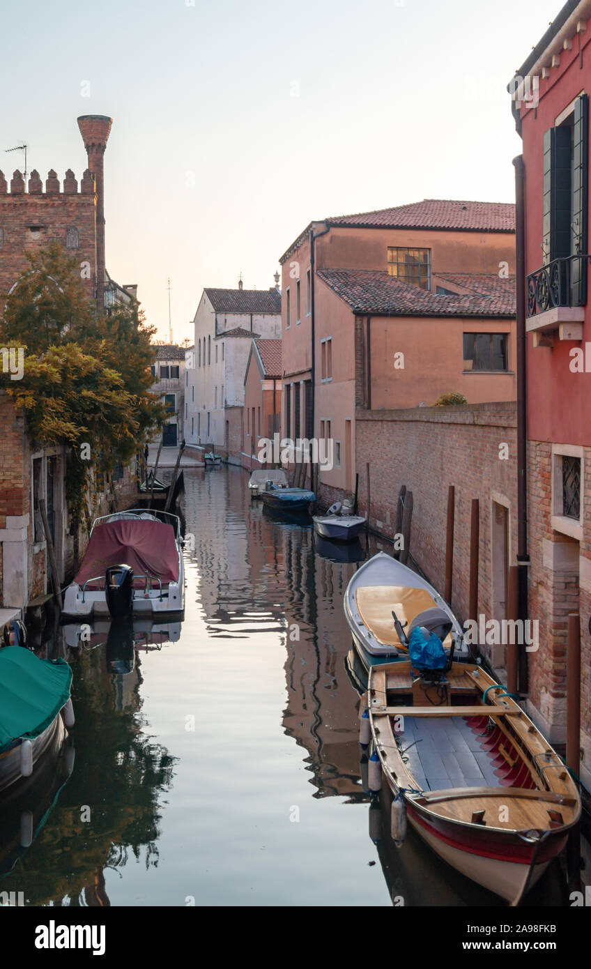 Venice, Italy. Narrow channel with moored boats Stock Photo - Alamy