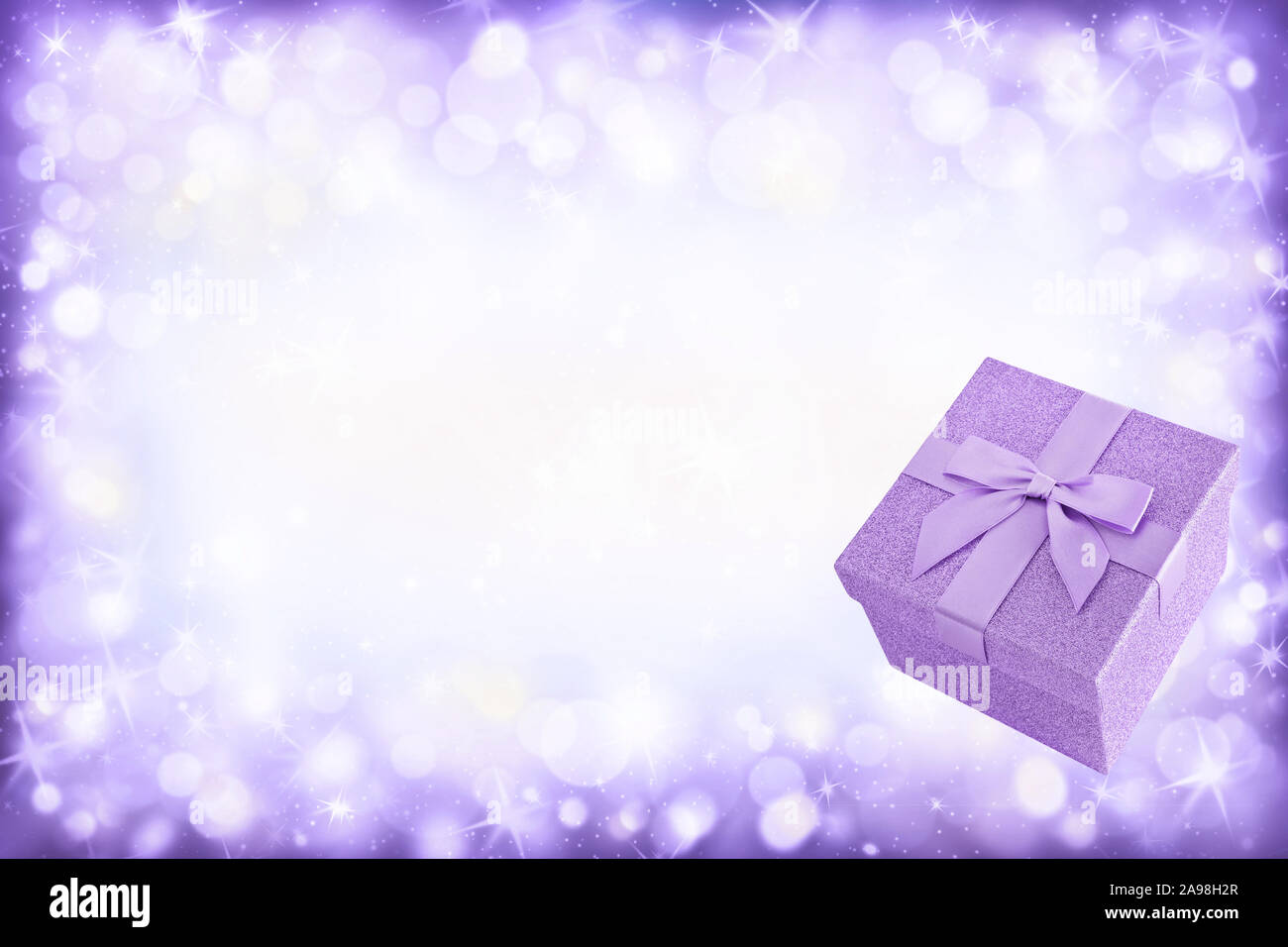 Sparkling background with violet gift box Stock Photo - Alamy