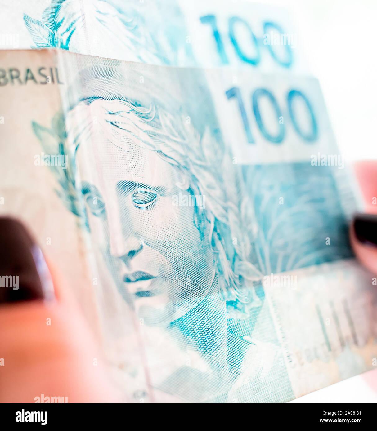 Brazilian currency. Photo of a woman holding money bills, one hundred ...