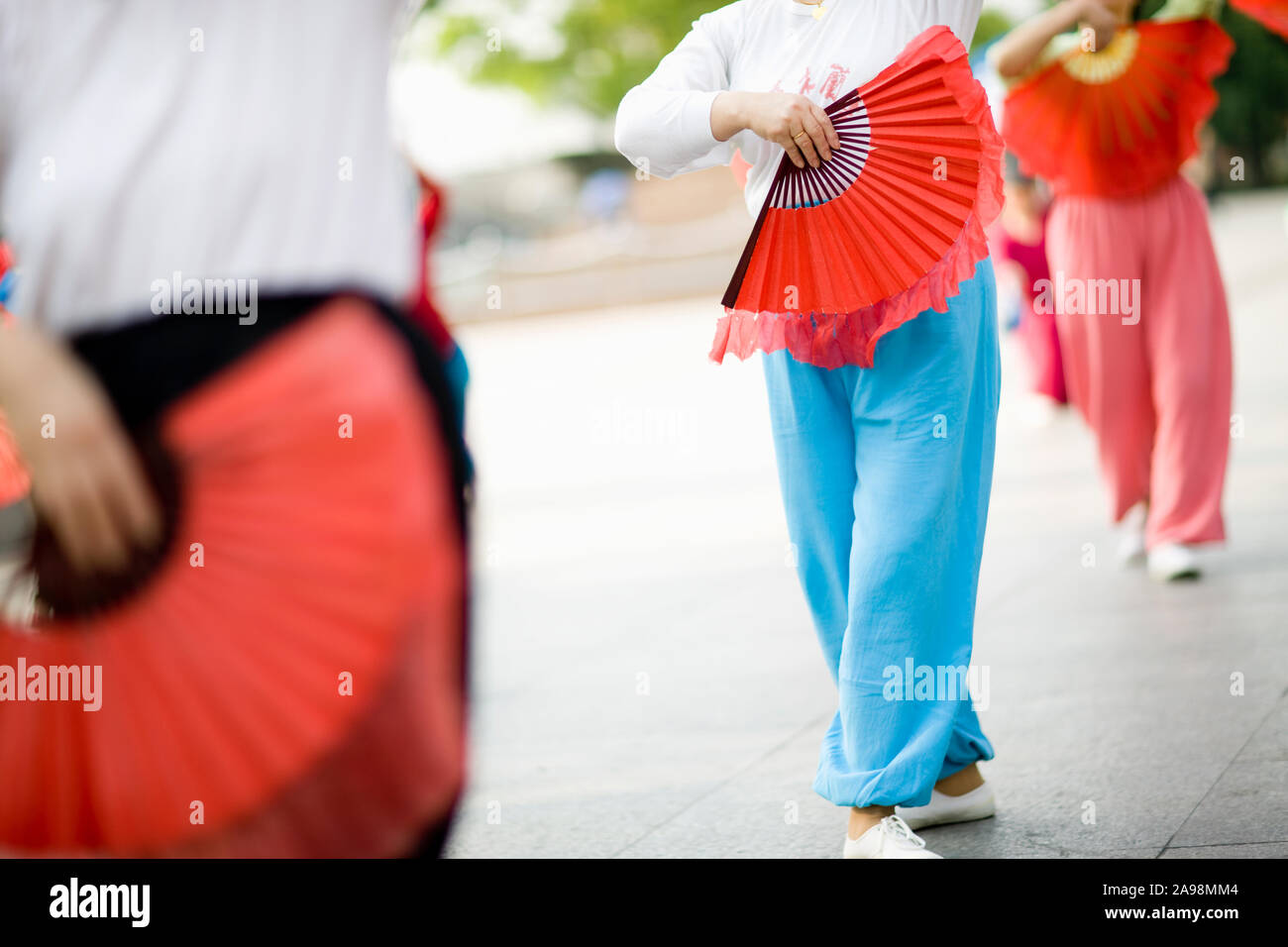 Fans being held during a traditional dance Stock Photo - Alamy