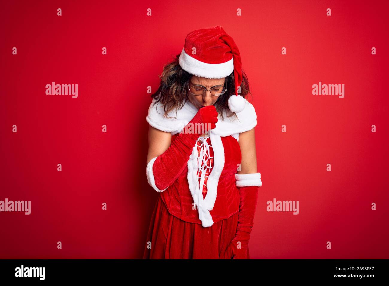 Middle age beautiful woman wearing Santa Claus costume over isolated ...
